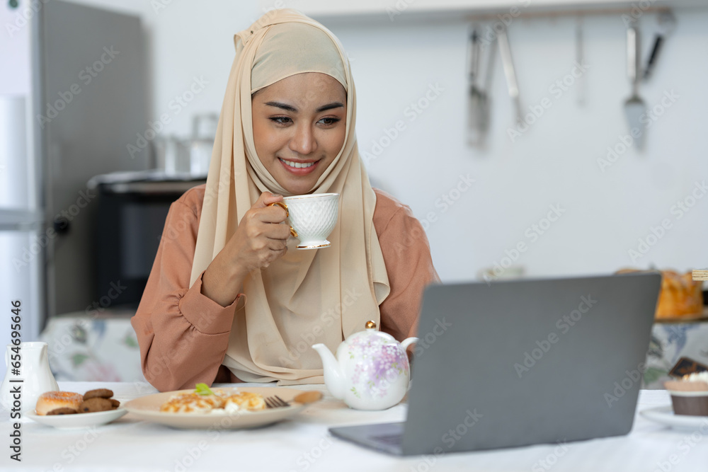 young muslim woman in hijab eating sweets, bread, waffles, cakes ...