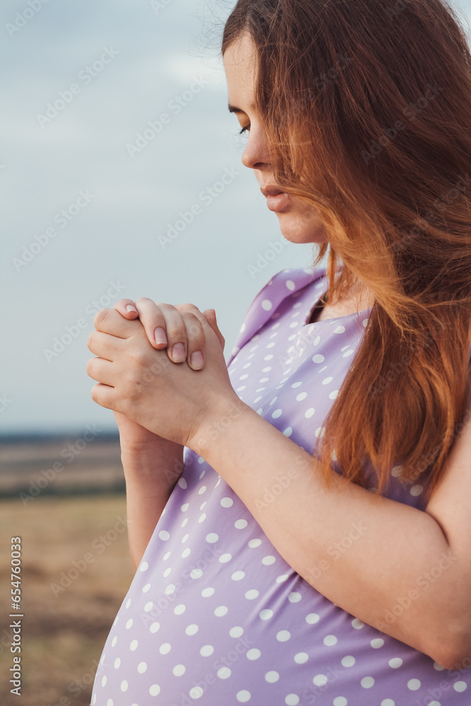 pregnant woman praying to God standing on field, gift of life Stock ...