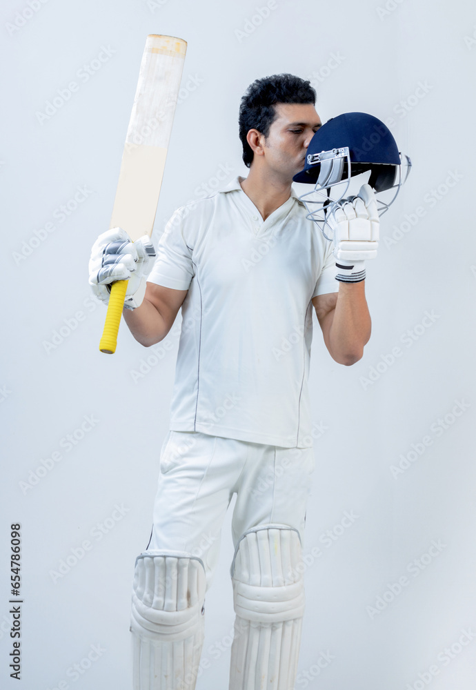 Indian man In cricket dress kissing helmet and showing his bat ...