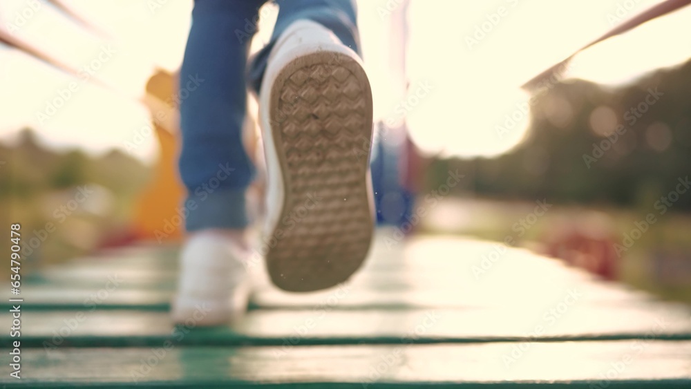 child daughter legs walking on the playground. happy family kid dream ...