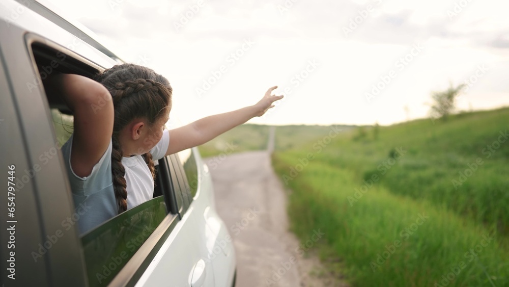free girl child hand from the window rides in a car wind in the face ...