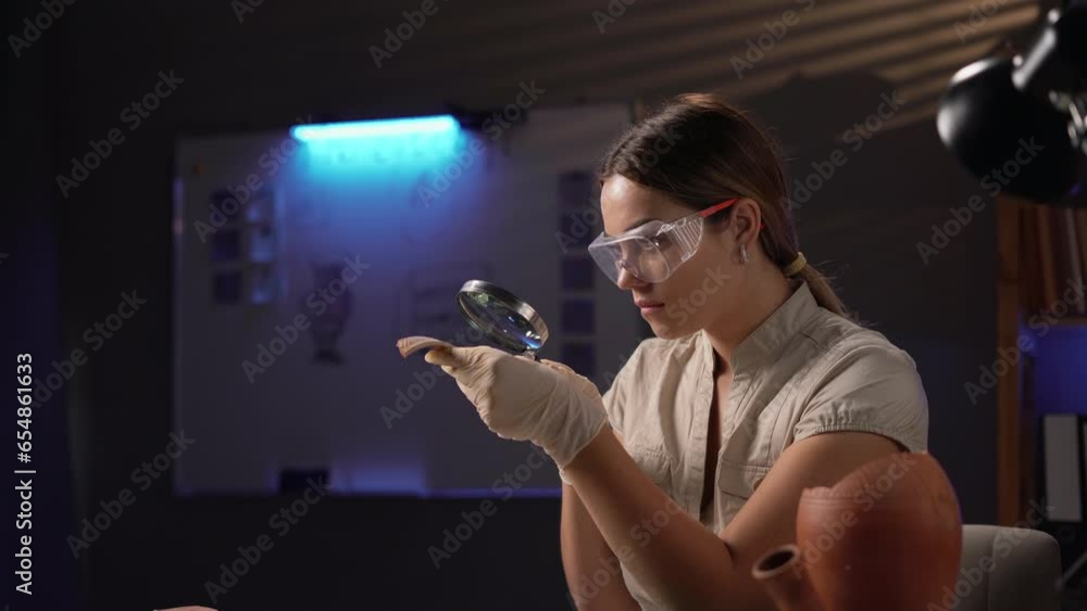 Video Stock Female archaeologist conducting cultural research discovers ...