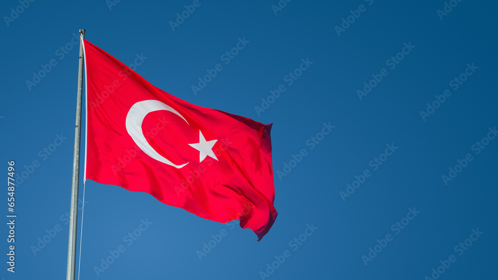 Banner with red Turkish national flag holding white crescent moon and ...