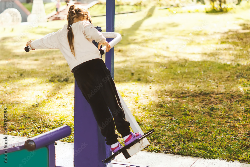 Cute little girl training on sports equipment. Happy little girl ...