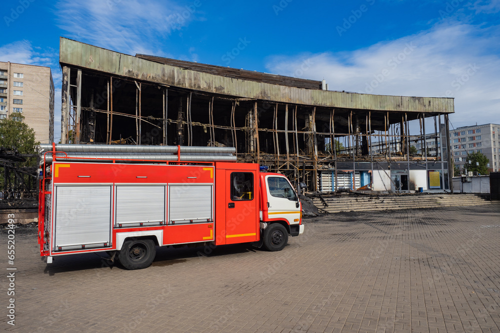 Fire department car. Burnt city building. Two-story house was damaged ...