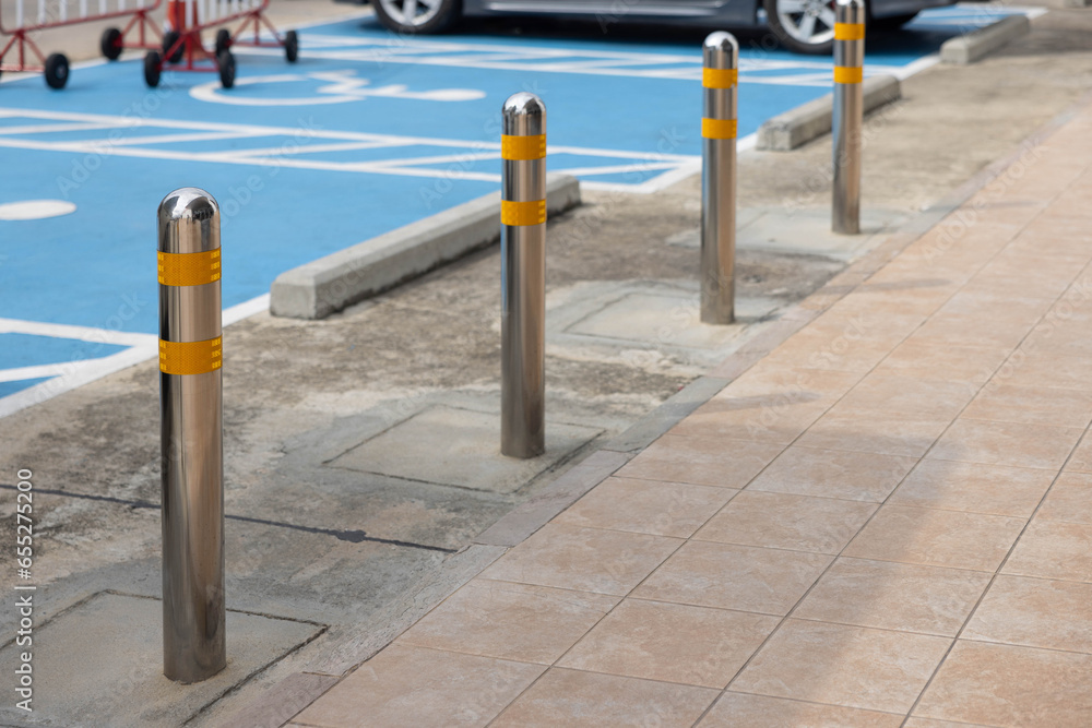 stainless steel bollards on pathway with the disabled parking lots as ...