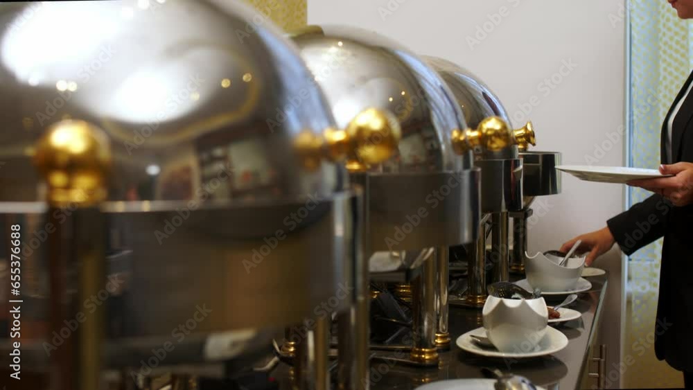 Self-service lines in an upscale hotel, a group of people pour out hot ...