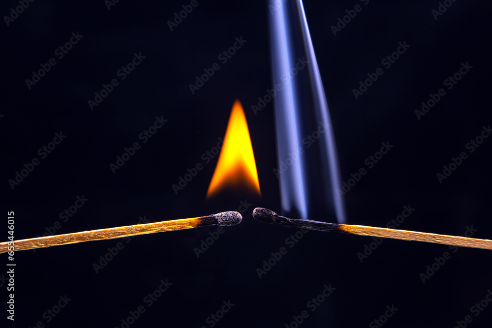 Fire and smoke. Burning and smoking match on a black background. Heat ...