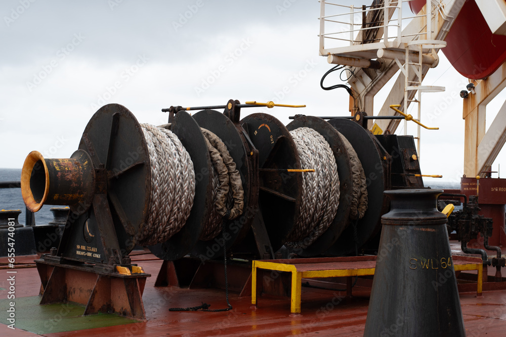 mooring winches with hawsers wrapped on it at the poop deck of a cargo ...