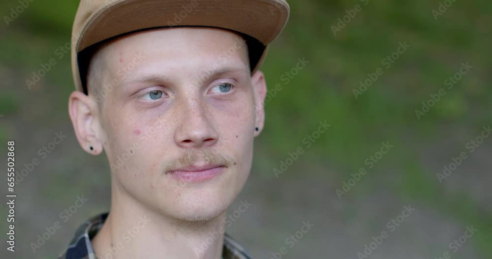Close-up portrait of teenage boy smiling into the camera, focus on his ...