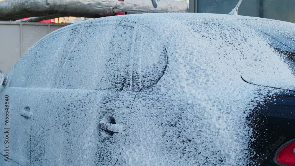 Washing luxury black car on touchless car wash. Cleaning the details of ...