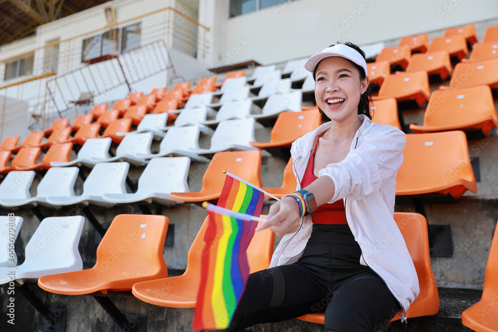 Happy and excited young female asian transgender LGBT sport fan ...