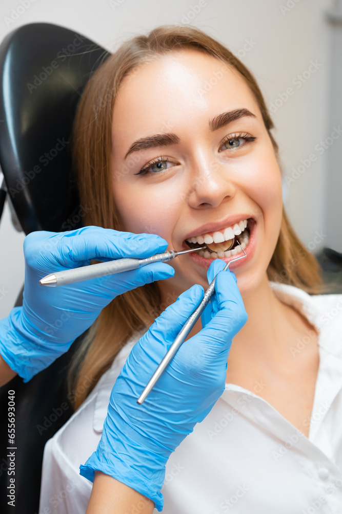Close-up woman patient sitting in armchair during dental treatment in ...