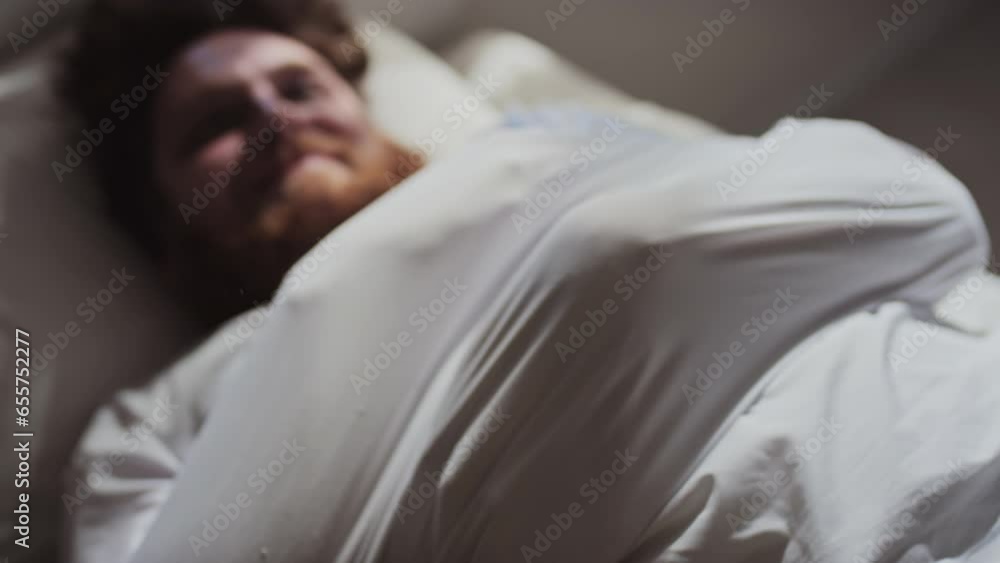 Selective focus shot of young male patient wearing straitjacket lying ...