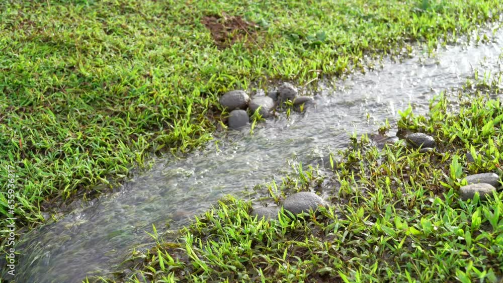 Water flowing in farm field waterway after heavy rain and storms caused ...