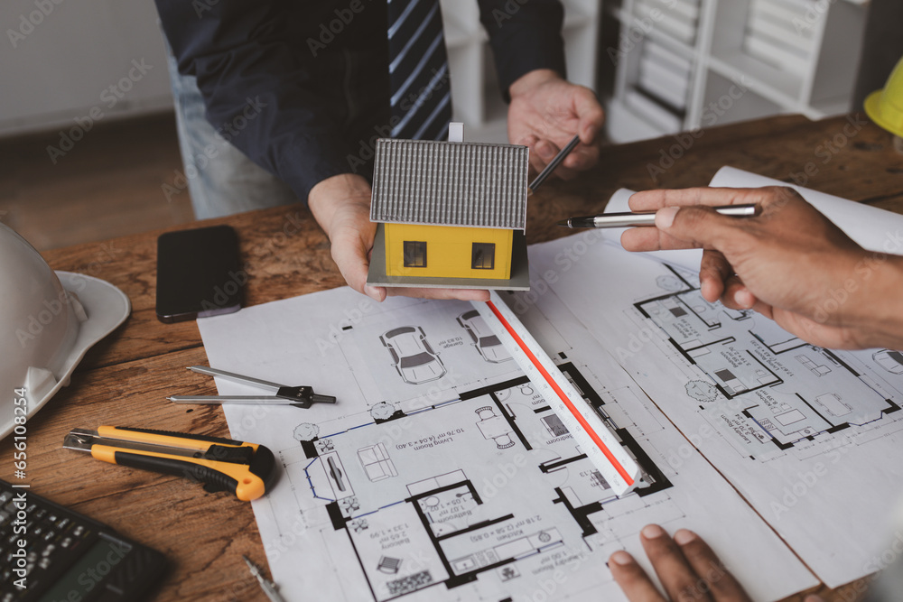 The home design architects are reviewing the house plan draft, the ...