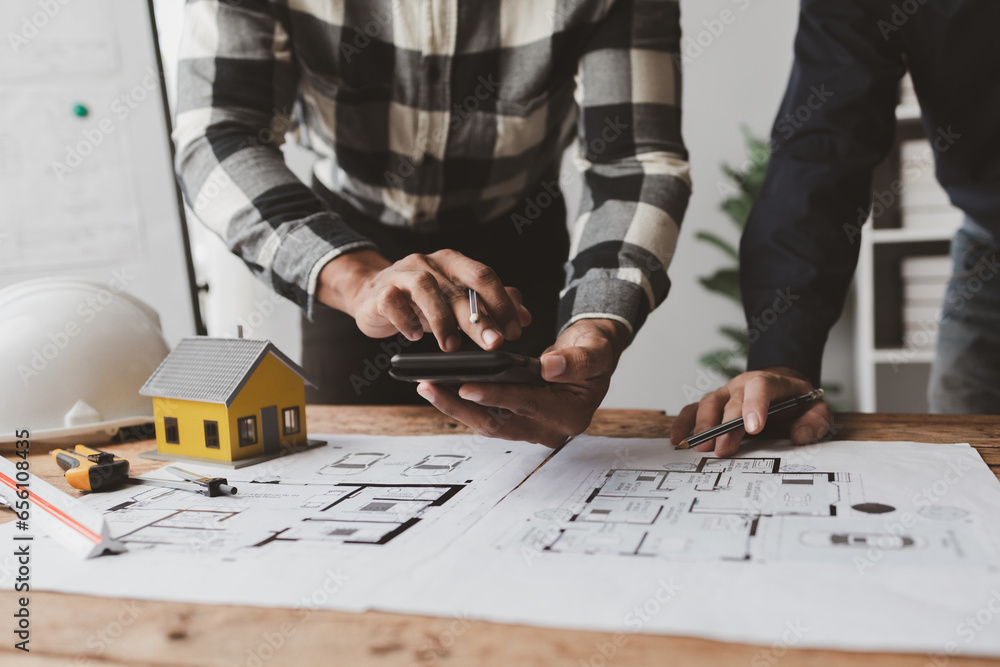 The home design architects are reviewing the house plan draft, the ...