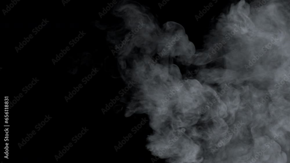 Smoke moving sideways revealing himself on a black background. A ...