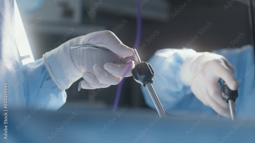Hands close up of professional surgeons performing operation using ...