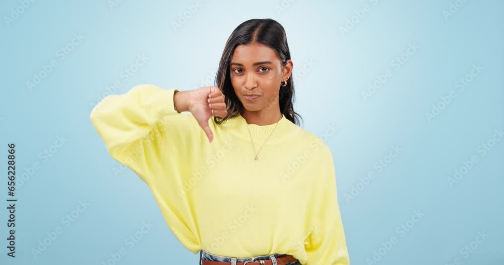 Sad, face and woman with thumbs down in studio for no, vote or bad ...