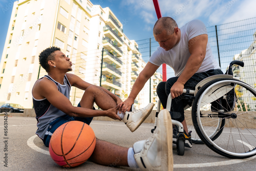 young black man holding on to a sprained ankle during a game, a sports ...