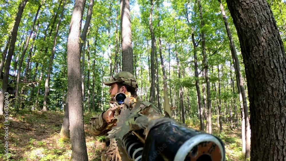 The camera on the bath of weapons. The military sniper in the helmet is attacking and assaulting ...