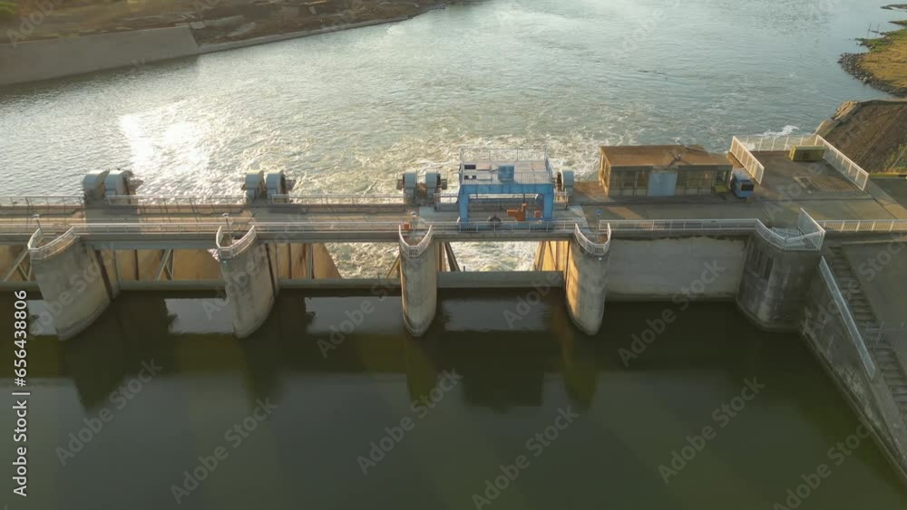 Fly over rear of dam wall at capacity, tilt down to reveal water ...