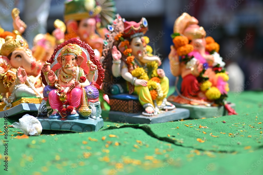 Small statues of the lord Ganesha in the street. God with Elephant face ...