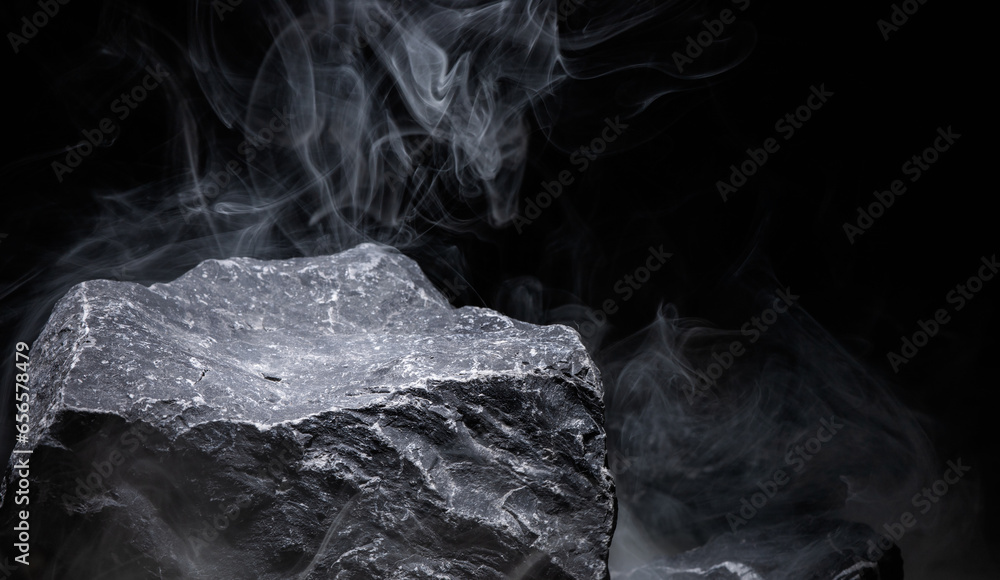 Mountain rock and floating smoke on a black background are for ...