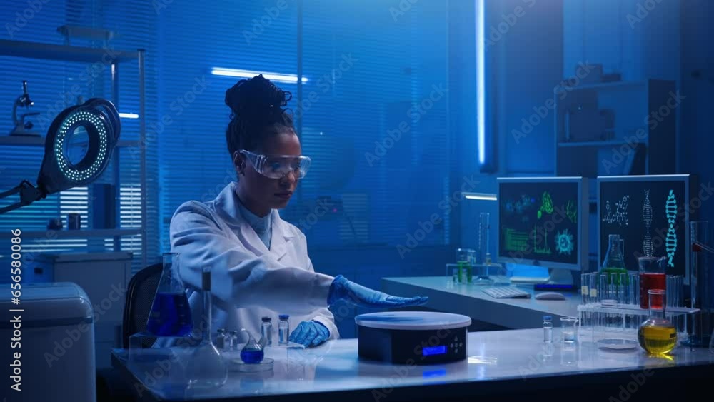 Medium-sized video capturing a dark-skinned female scientist wearing ...
