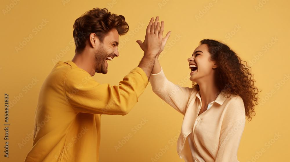 Side view of cheerful boyfriend and girlfriend giving high - five to ...