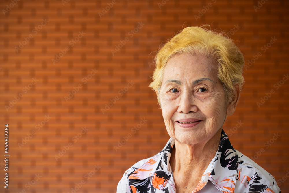 Close-up face of a asian modern grandmother, in a half-body portrait ...