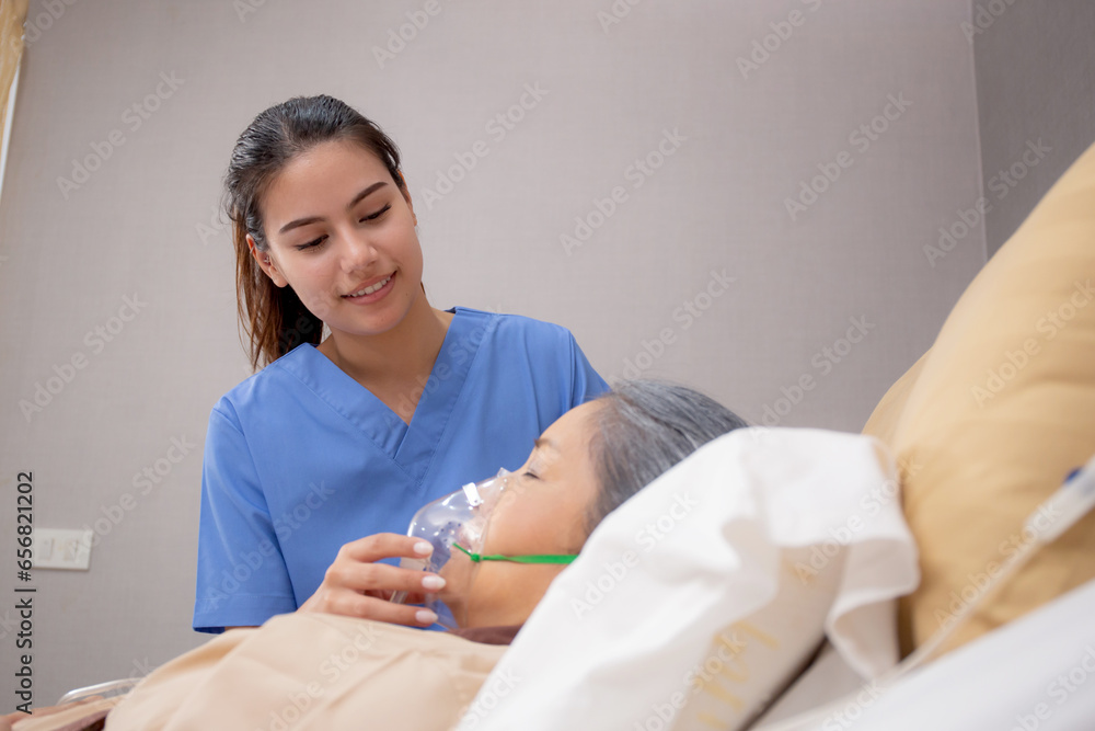 Nurse putting oxygen mask with patient elderly woman on bed for ...