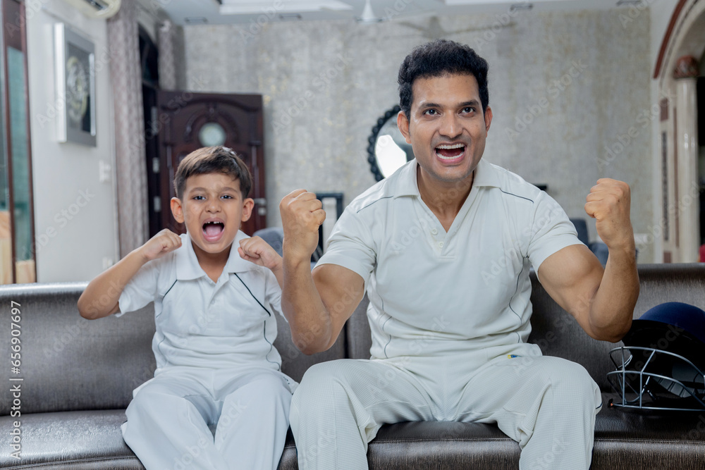 Indian Father and son in cricket dress watching cricket and supporting ...