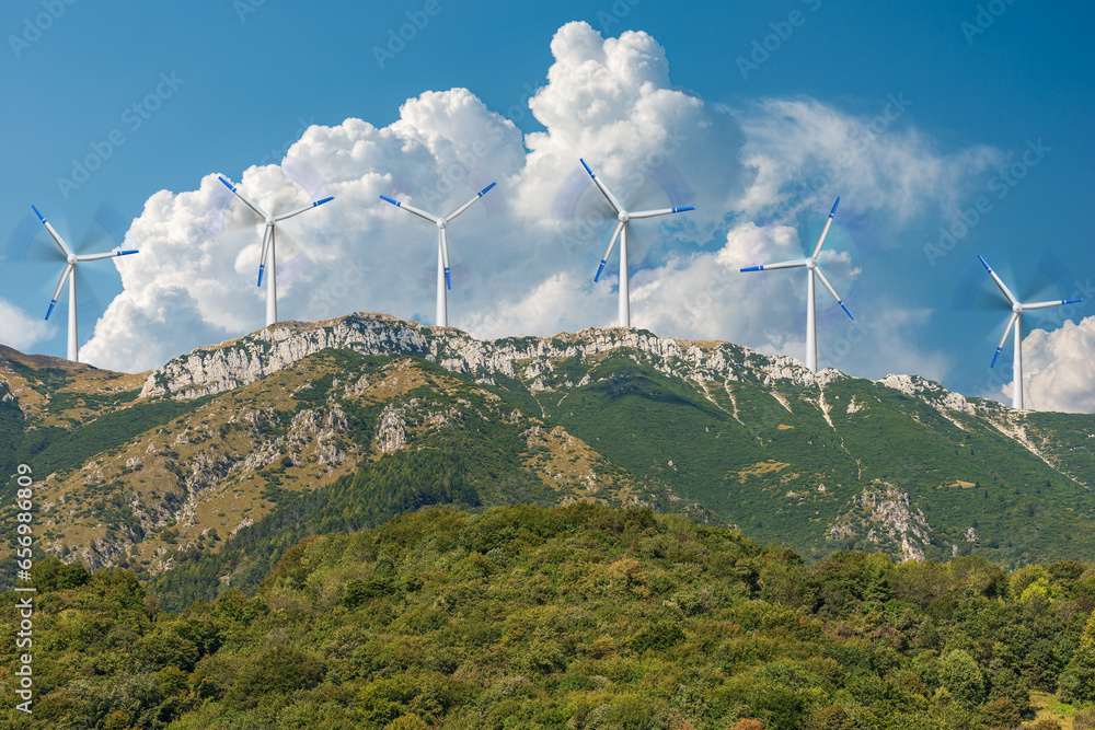 Group of white and blue wind turbines on the top of a mountain range ...
