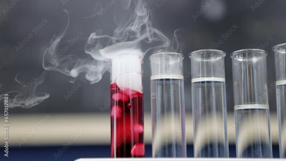 In a close-up view, a set of lab test tubes comes to life. One tube ...