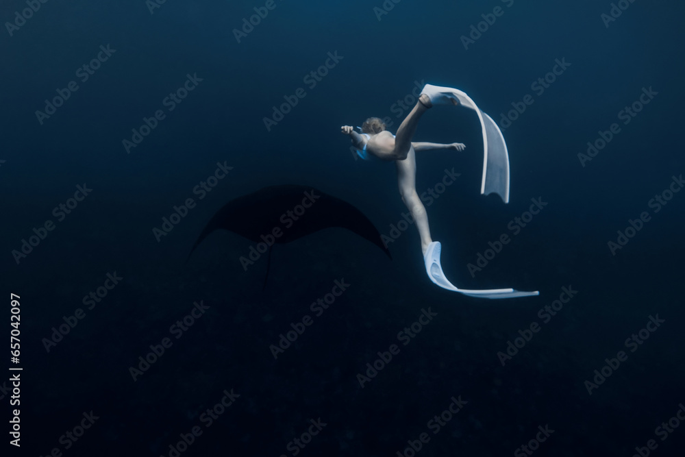 Woman underwater with manta ray. Freediving with manta rays on deep ...