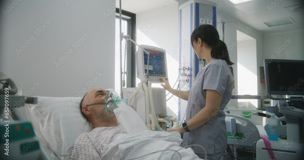 Emergency room with modern equipment in clinic. Senior man in oxygen ...