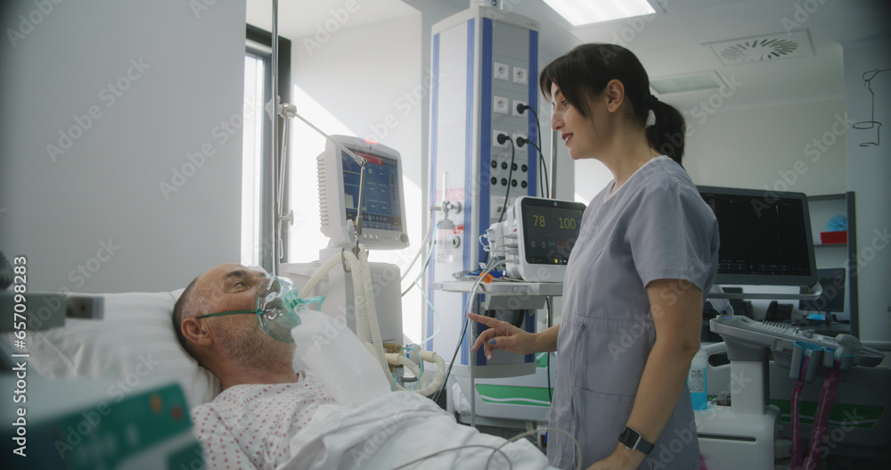 Emergency room with modern equipment in clinic. Senior man in oxygen ...