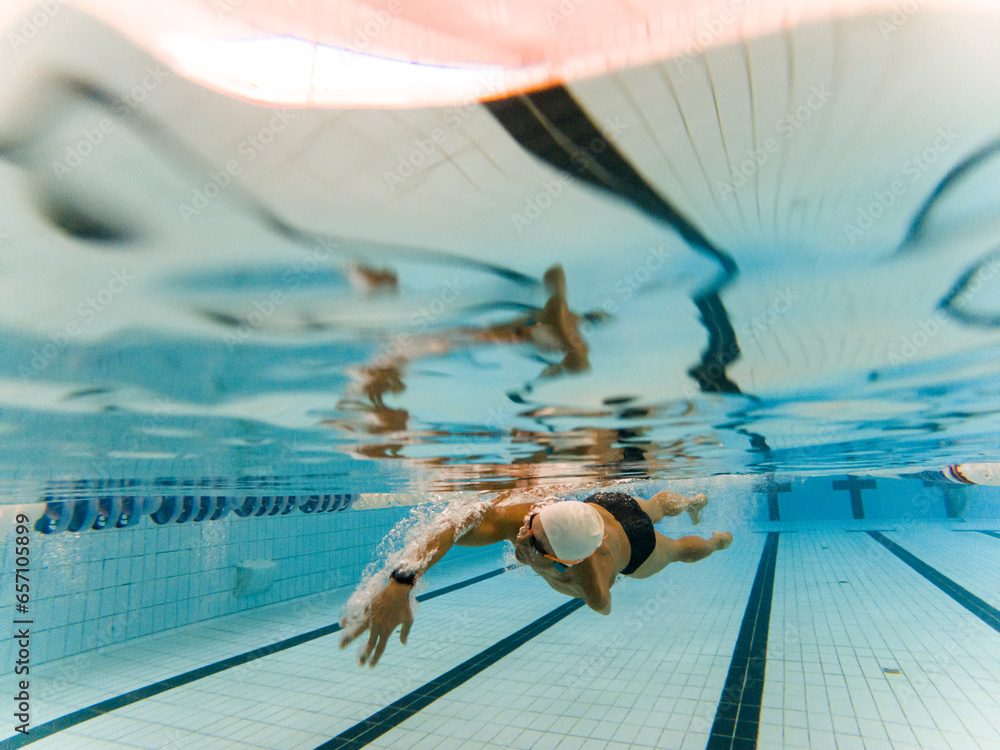 Underwater photo of an adult man with an amputated arm swimming in an ...