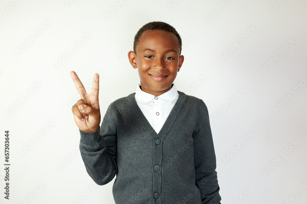 Happy smiling cool school kid of african ethnicity showing victory or ...