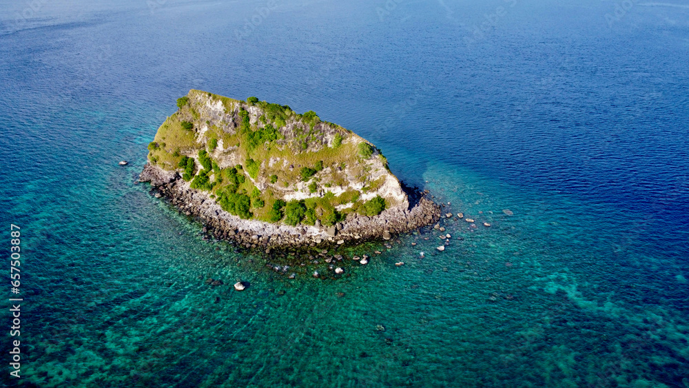 Small rocky uninhabited island in the ocean. Aerial view of an ...