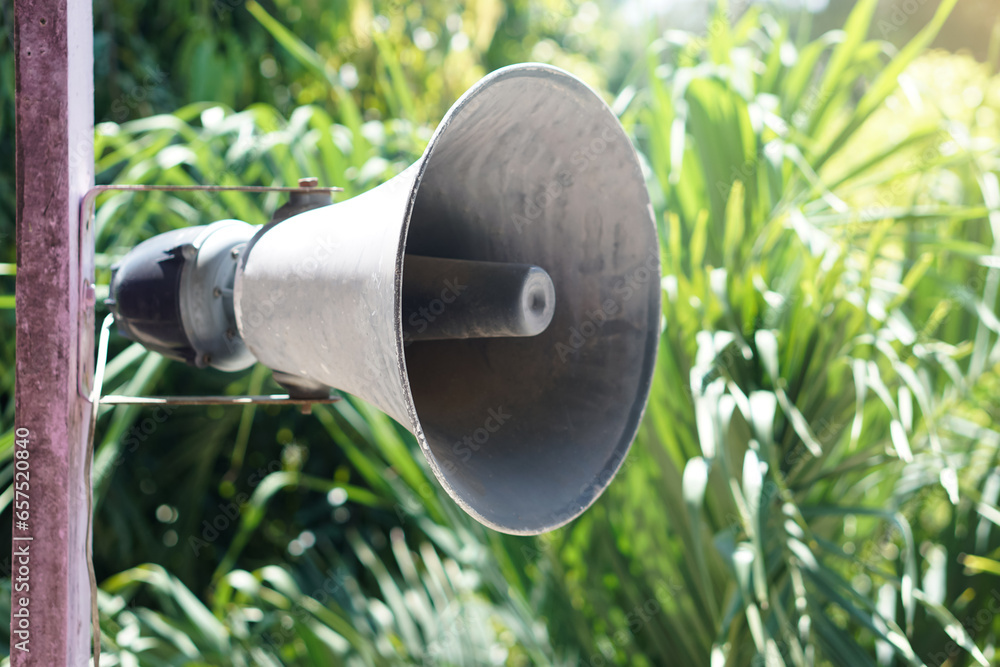 Vintage bullhorn, megaphone, speakers was installed on pole with green ...