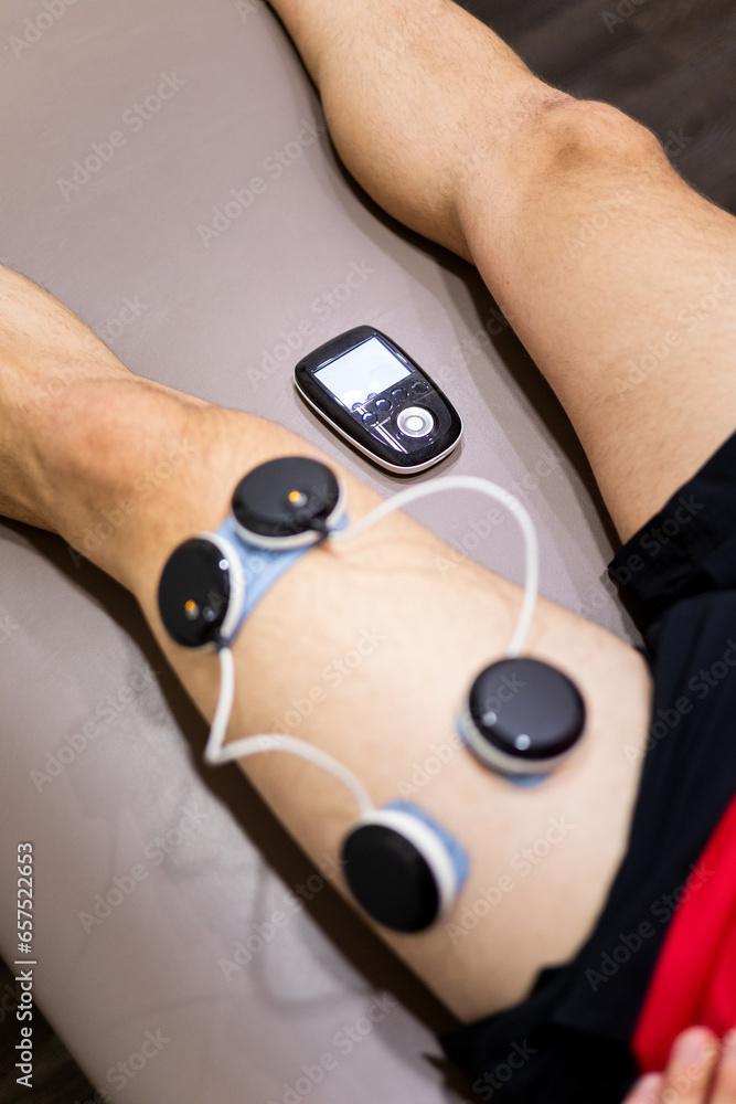 Vertical photo of the legs of an injured patient in a physiotherapy ...