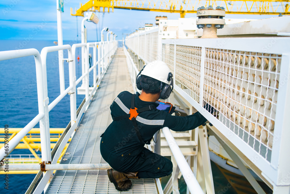 Non-destructive testing technicians are checking the thickness of pipes ...