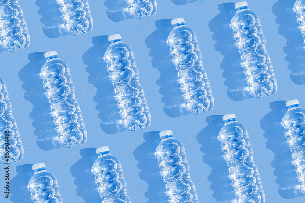 Minimal Pattern Plastic bottles water at sunlight with shadow on blue ...