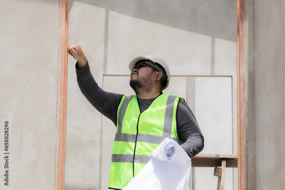 Asian overweight construction project foreman inspects construction ...