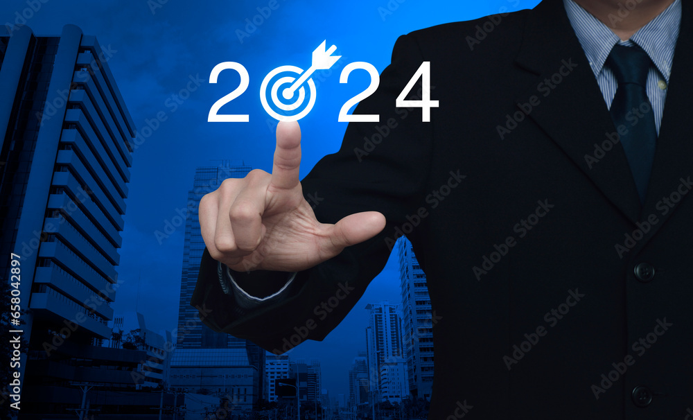 Businessman pressing 2024 letter with goal icon over modern office city ...