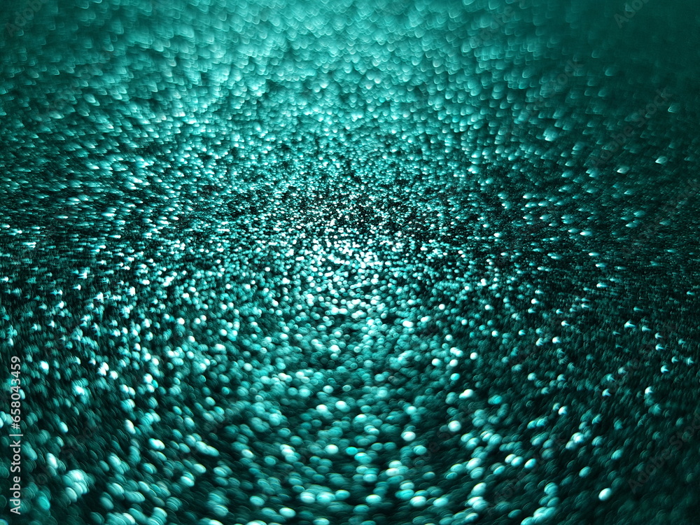 Turquoise sparkling fluorescent paper on artificial light (macro, angle ...