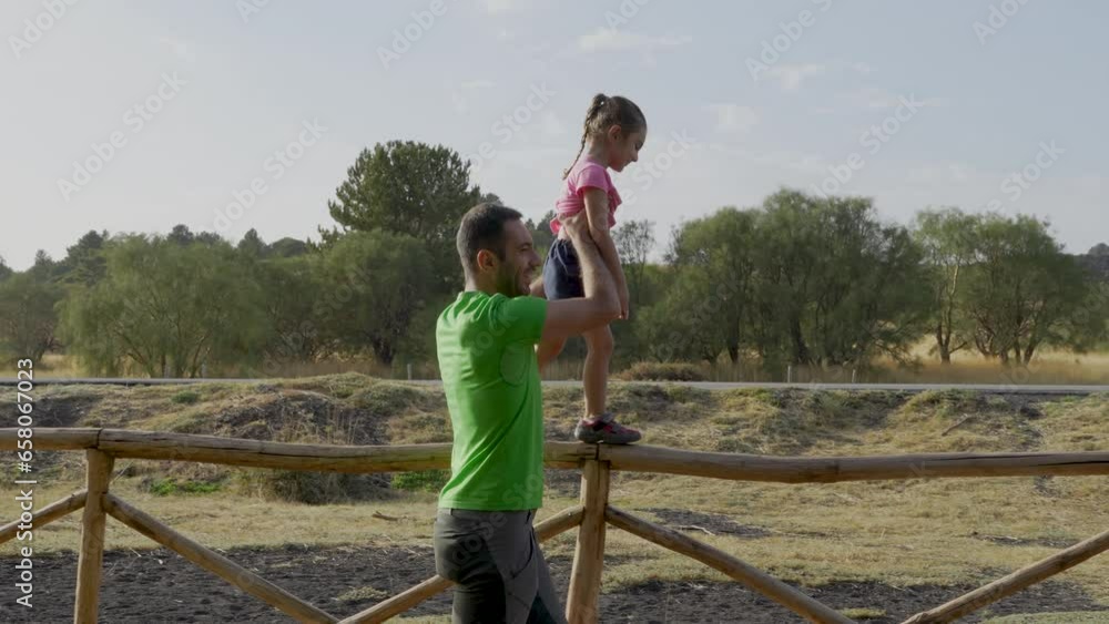 Father Teaching Daughter on Countryside Fence - Dad carefully guides ...